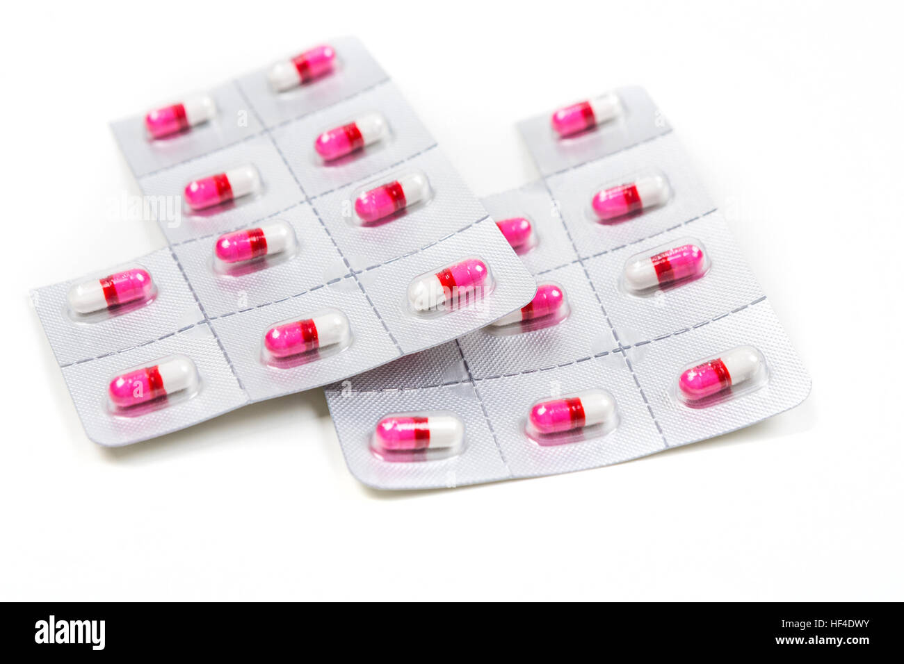 Pink and white pills in blister packs isolated on white background ...