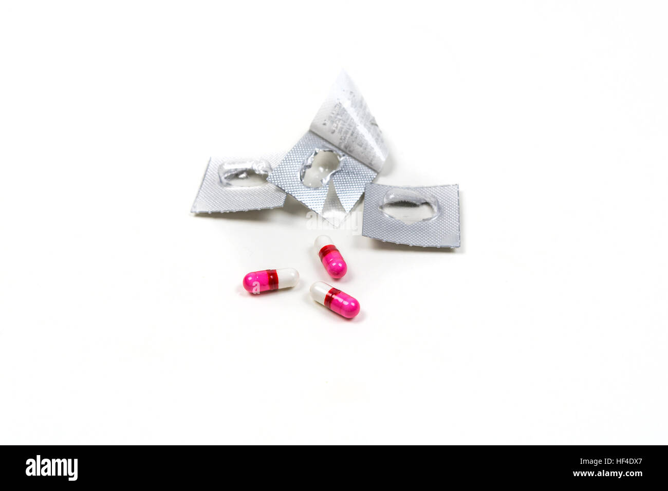 Opened pink and white pills isolated on white background Stock Photo ...