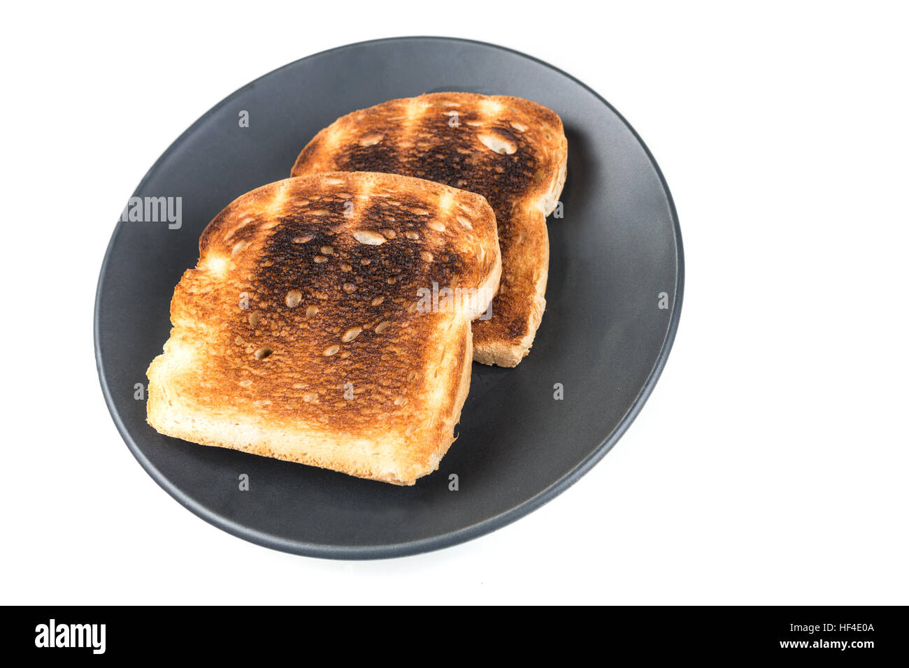 Burned whole grain toast isolated on white background Stock Photo - Alamy
