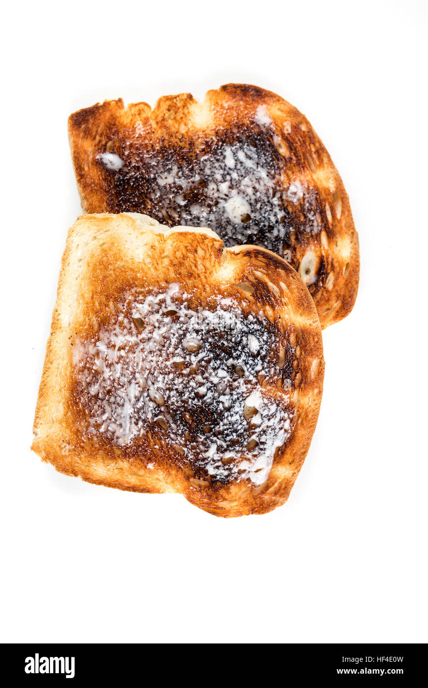 Burned whole grain toast isolated on white background Stock Photo - Alamy