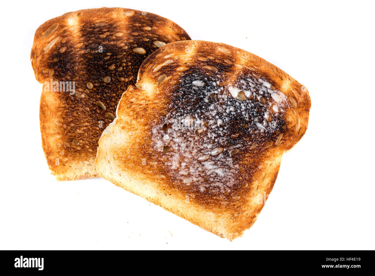 Burned whole grain toast isolated on white background Stock Photo - Alamy