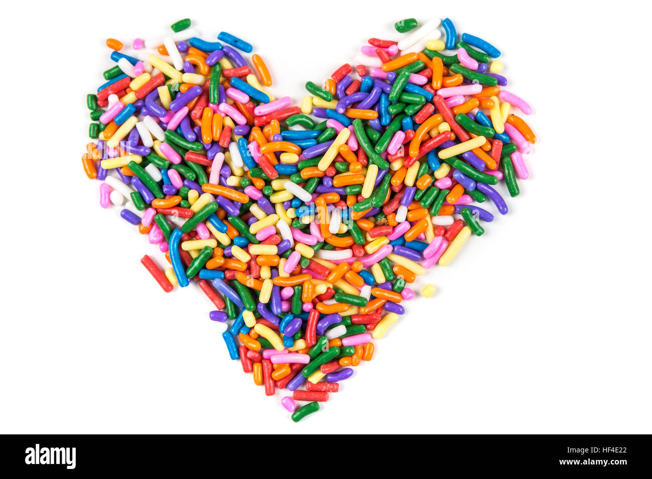 Heart shaped assorted rainbow colored sprinkles isolated on white ...