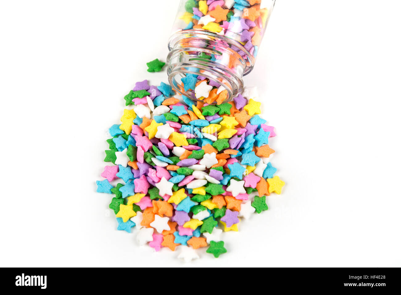 Assorted rainbow colored sprinkles and bottle isolated on white ...