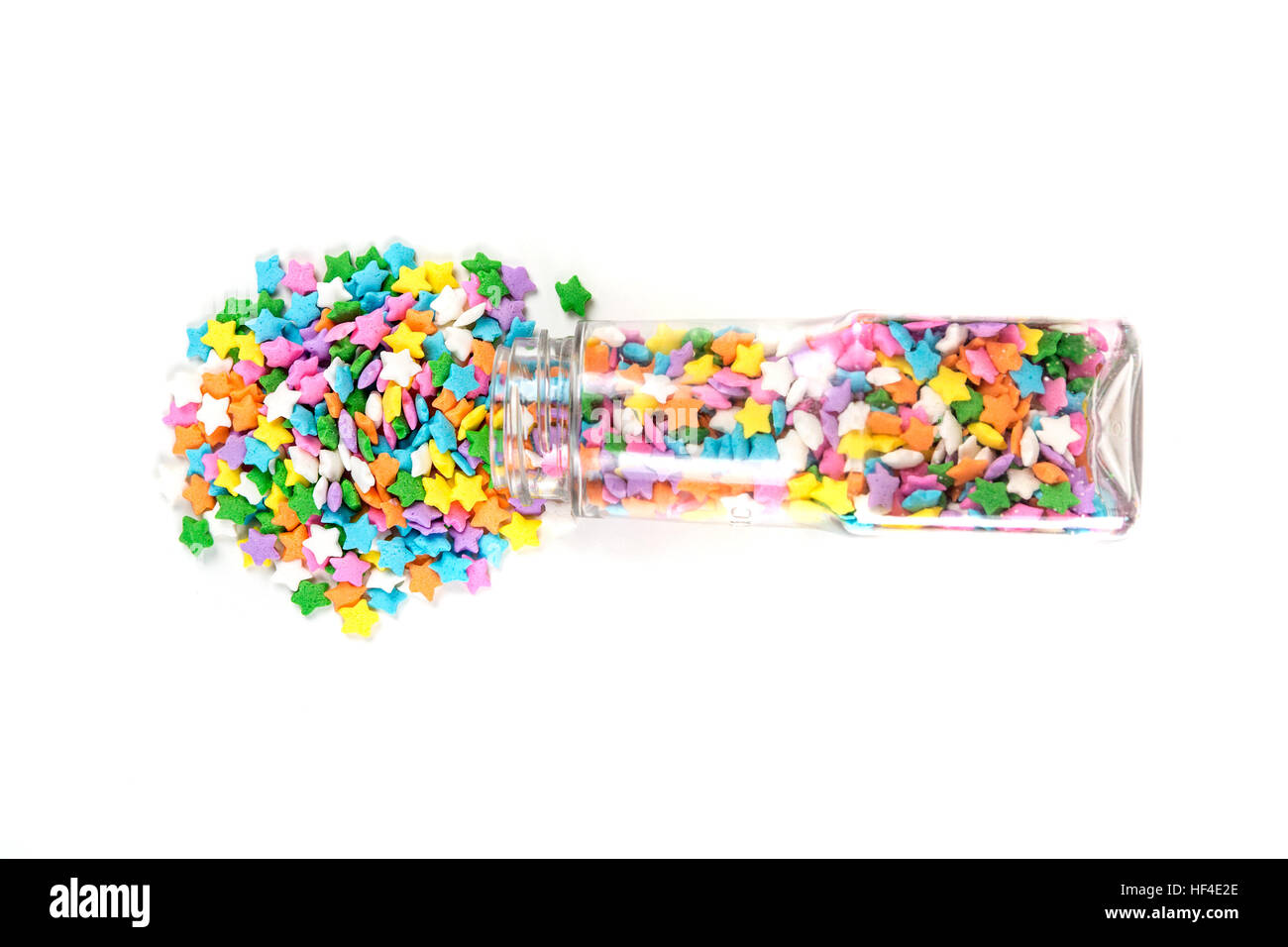 Assorted rainbow colored sprinkles and bottle isolated on white ...