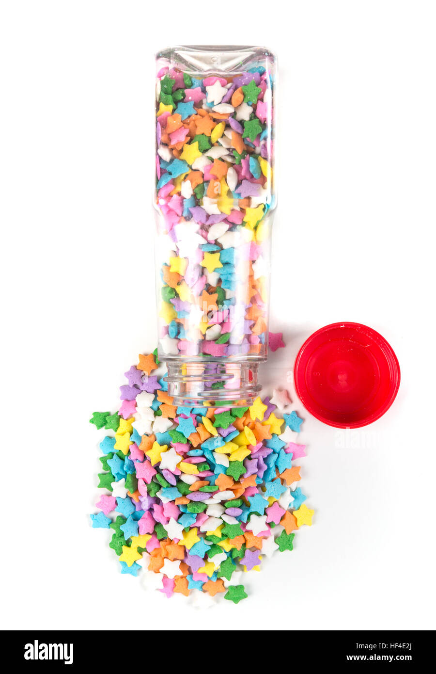 Assorted rainbow colored sprinkles and bottle isolated on white ...