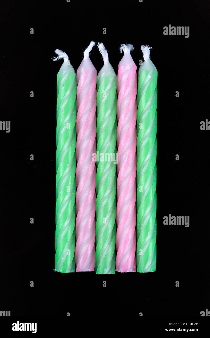 Assorted colored candles isolated on black background Stock Photo - Alamy