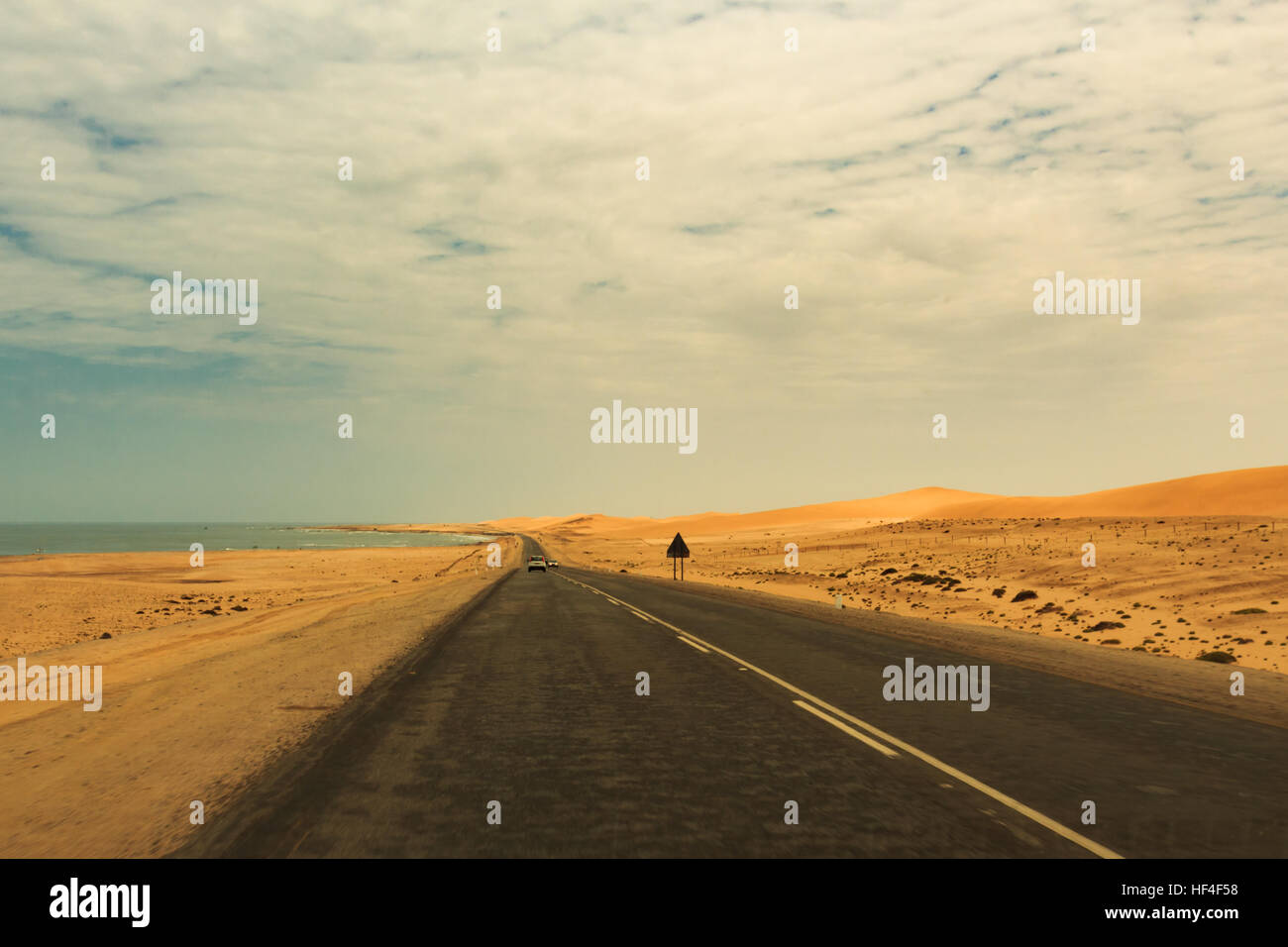 view from the road to the African dunes in the desert near the ocean ...
