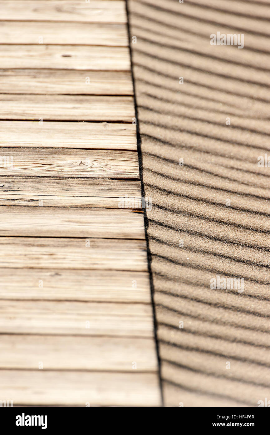 close up of wood in a beach with sand as background Stock Photo - Alamy