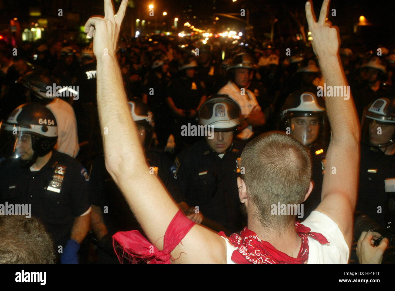 A protester makes peace signs against the police during a march against ...