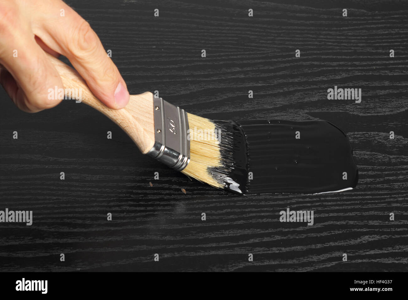Painting black wooden table Stock Photo - Alamy