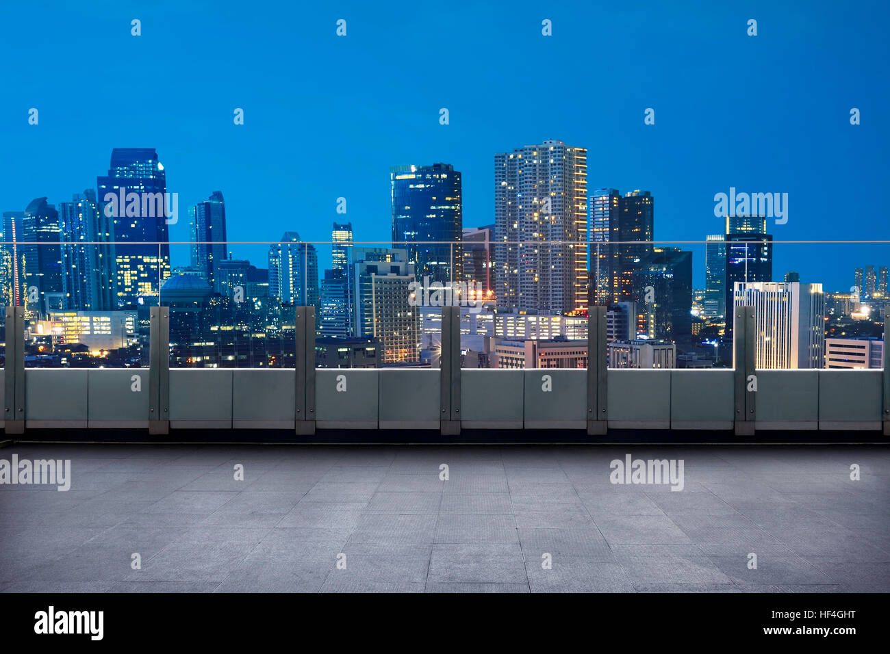 Empty terrace with cityscape and skyscraper at night Stock Photo - Alamy