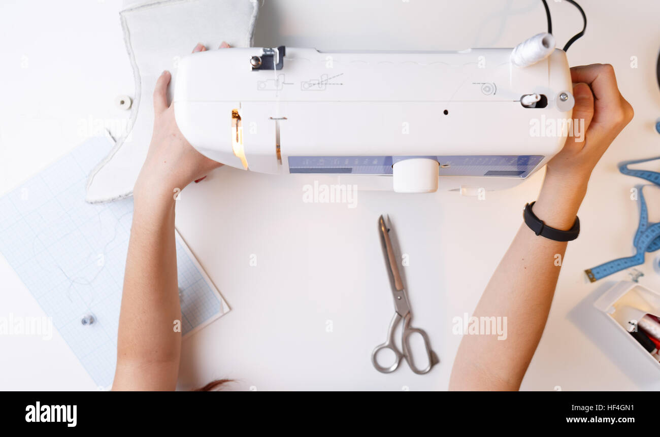 Girl with sewing machine top view photos indoors Stock Photo - Alamy