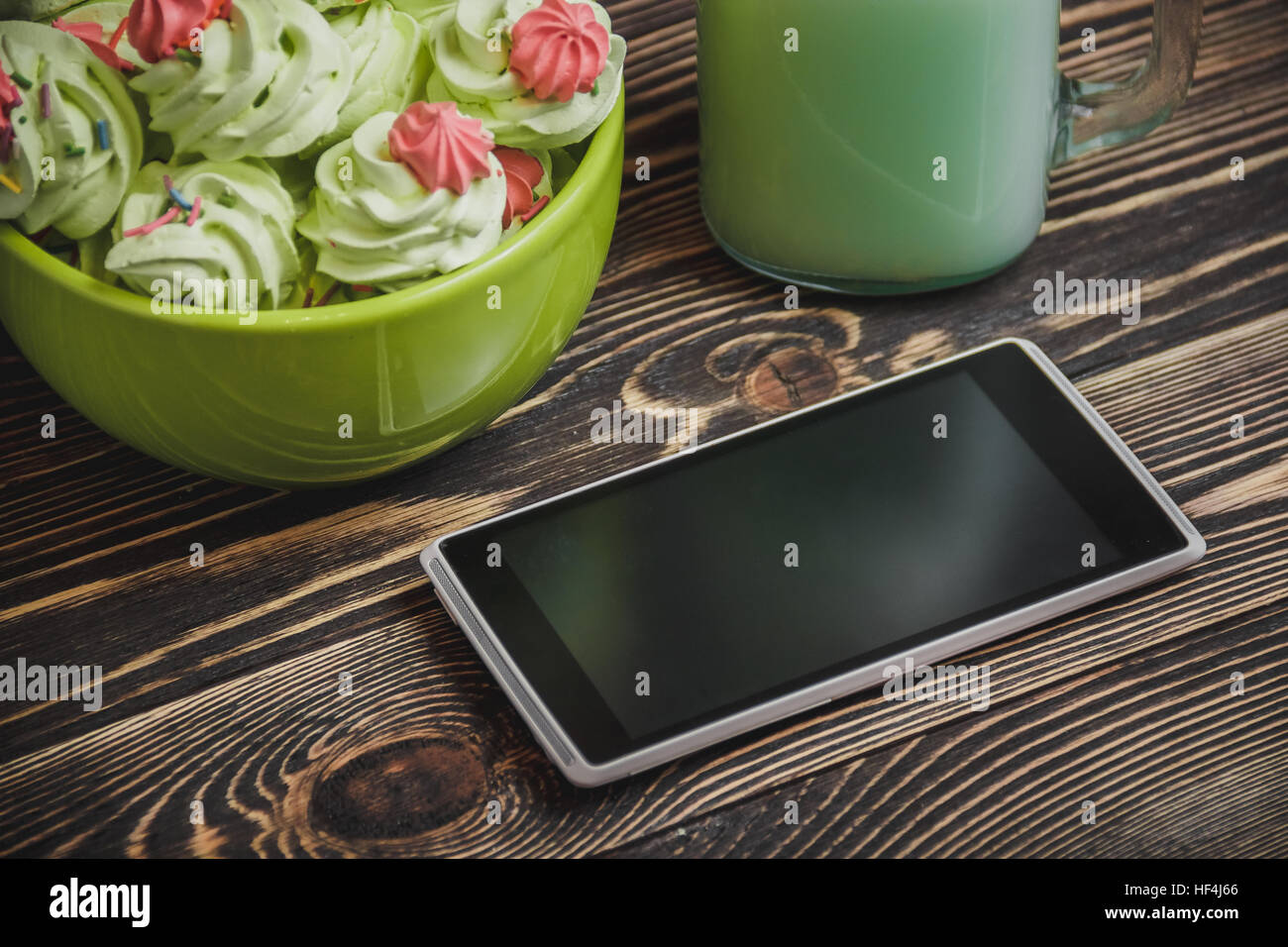 Close up of mobile phone lying on a wooden table Stock Photo - Alamy