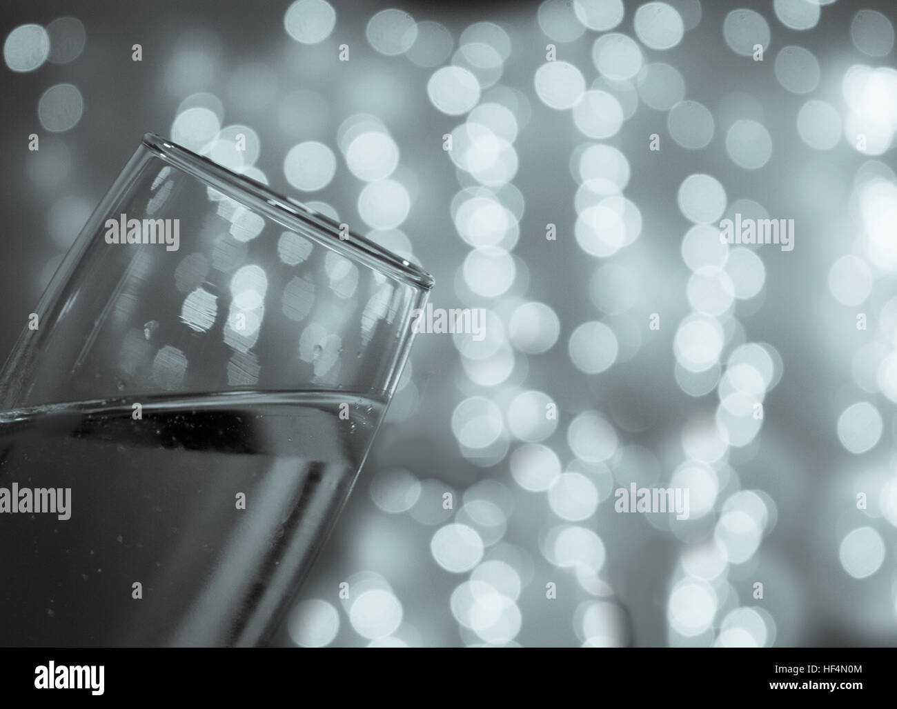 Toast with a champagne glass over defocused background Stock Photo - Alamy