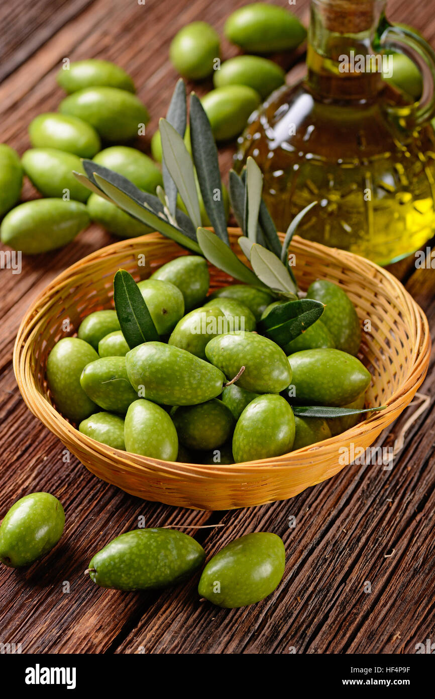 fresh green olives on the wooden table Stock Photo - Alamy