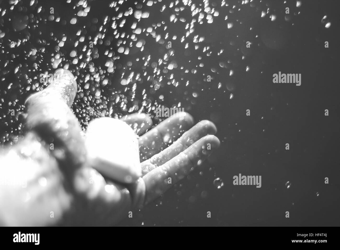 Photograph of an open human hand with soap under water drops Stock ...