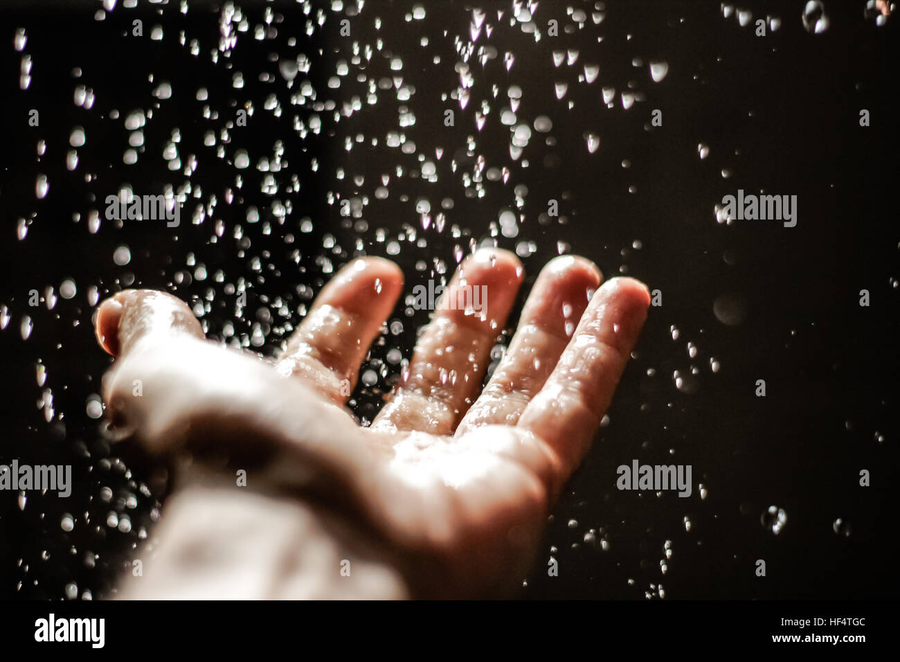 Photograph of an open human hand under water drops Stock Photo - Alamy