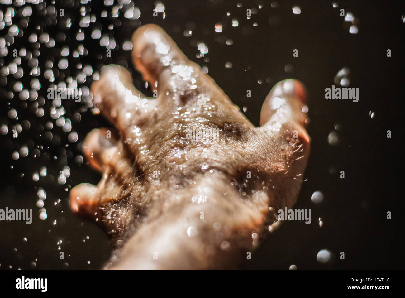 Photograph of an open human hand under water drops Stock Photo - Alamy