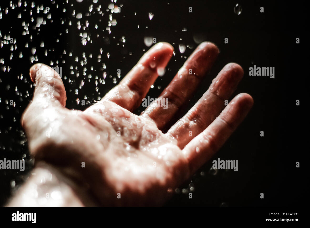Photograph of an open human hand under water drops Stock Photo - Alamy