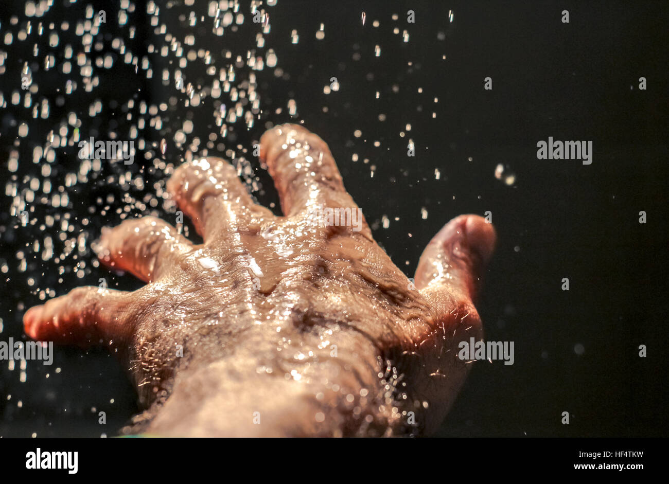 Photograph of an open human hand under water drops Stock Photo - Alamy
