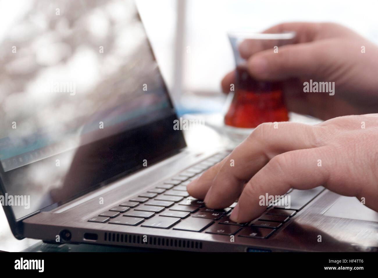 Businessman working with laptop and drinking Turkish tea Stock Photo ...