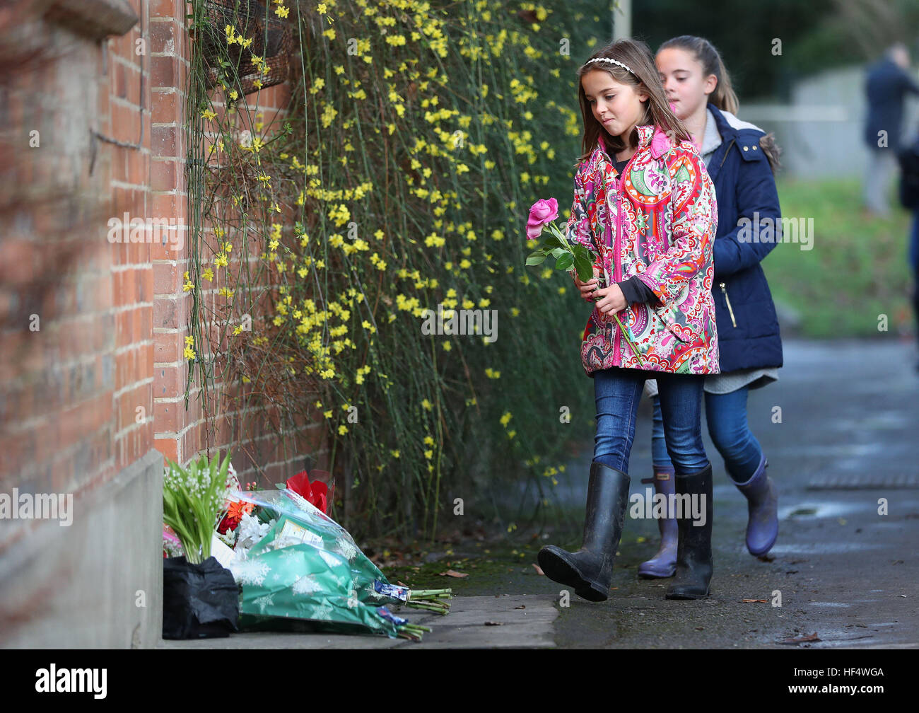 Children lay flowers outside the Goring house of George Michael in ...