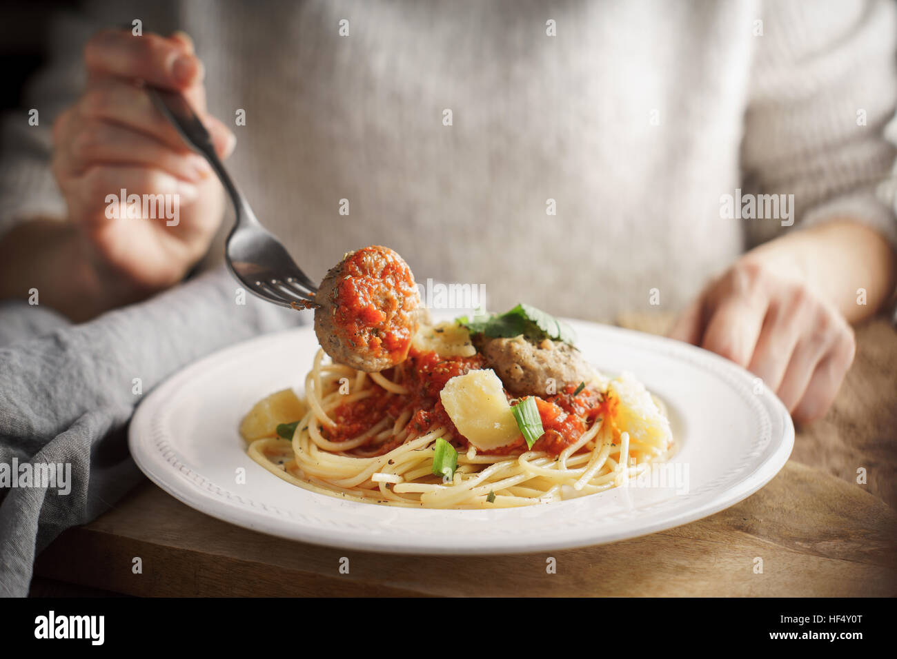 Woman eating meatballs horizontal Stock Photo - Alamy
