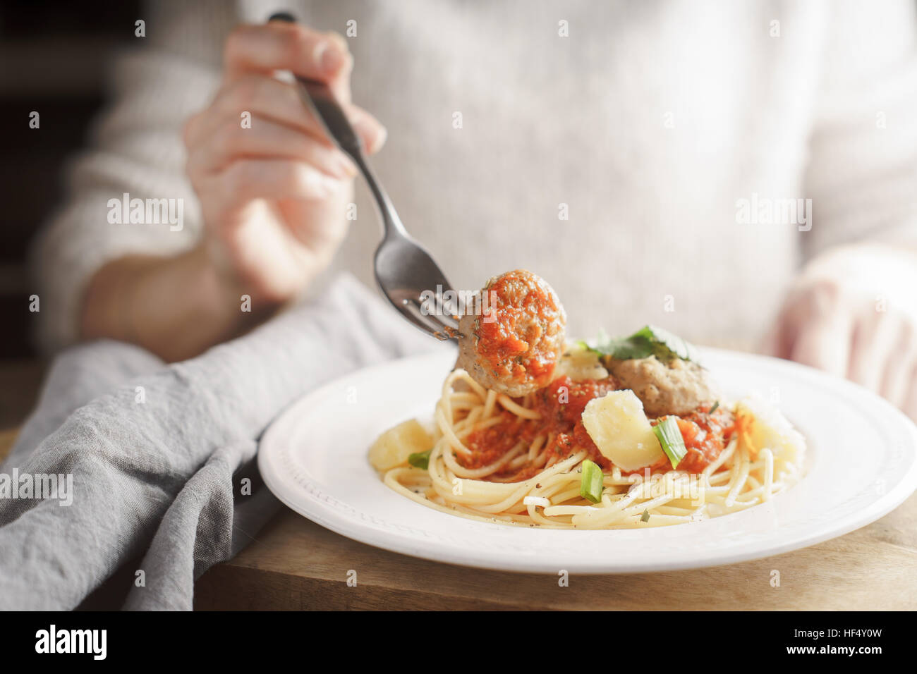Woman eating meatballs horizontal Stock Photo - Alamy