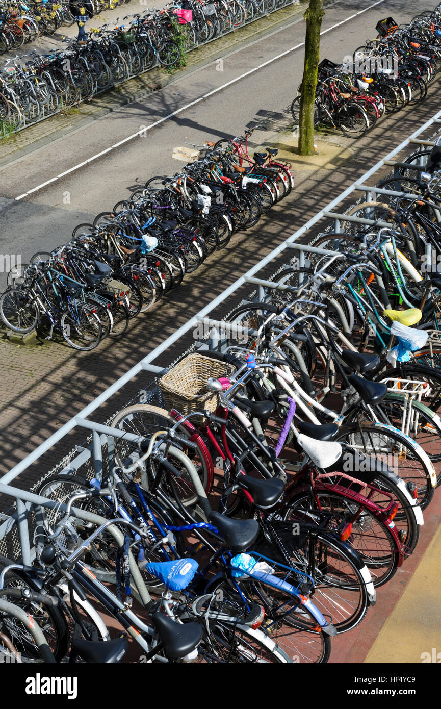 Bicycles in racks near the main train station in Amsterdam, Holland ...