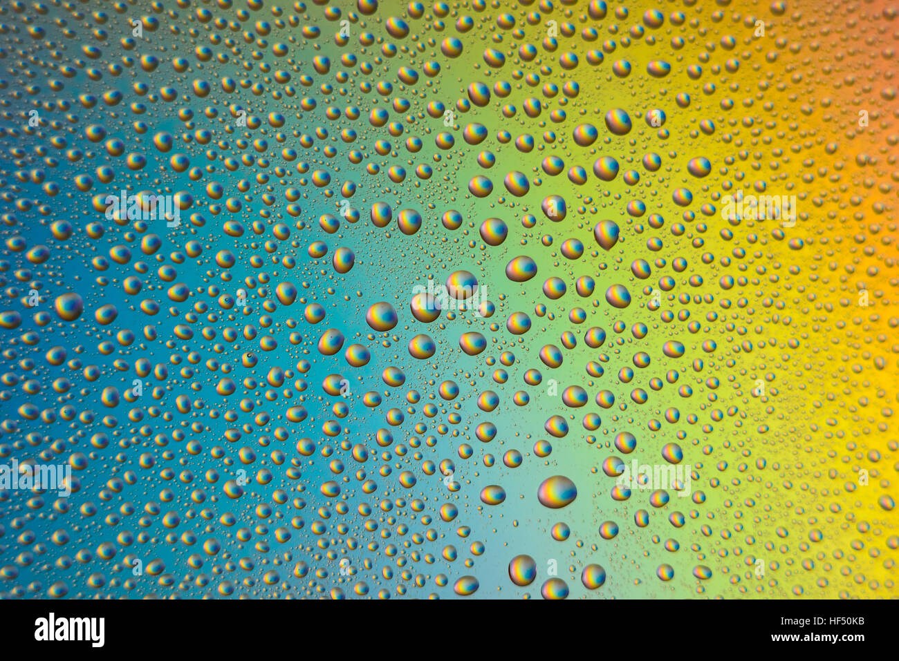 misted glass, the drops closeup on rainbow colored background Stock ...