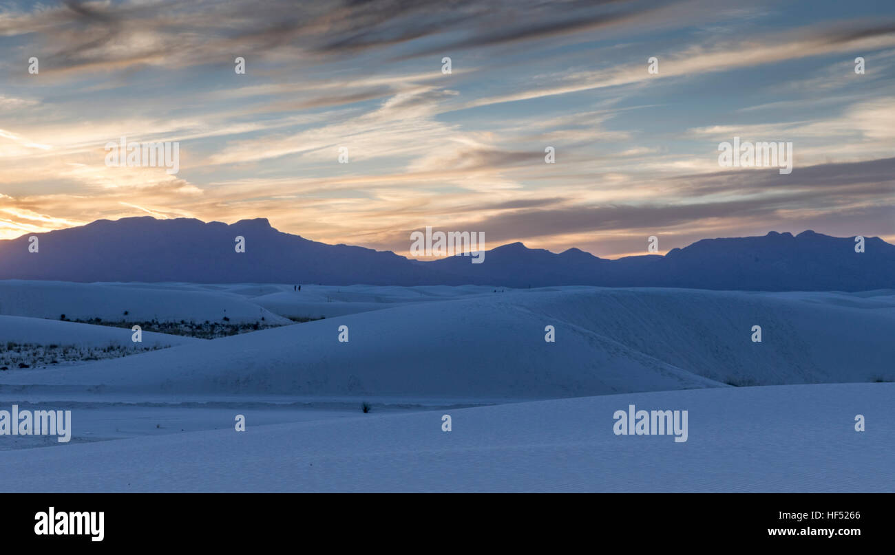 Two figures walking on white gypsum sand dunes at White Sands National ...