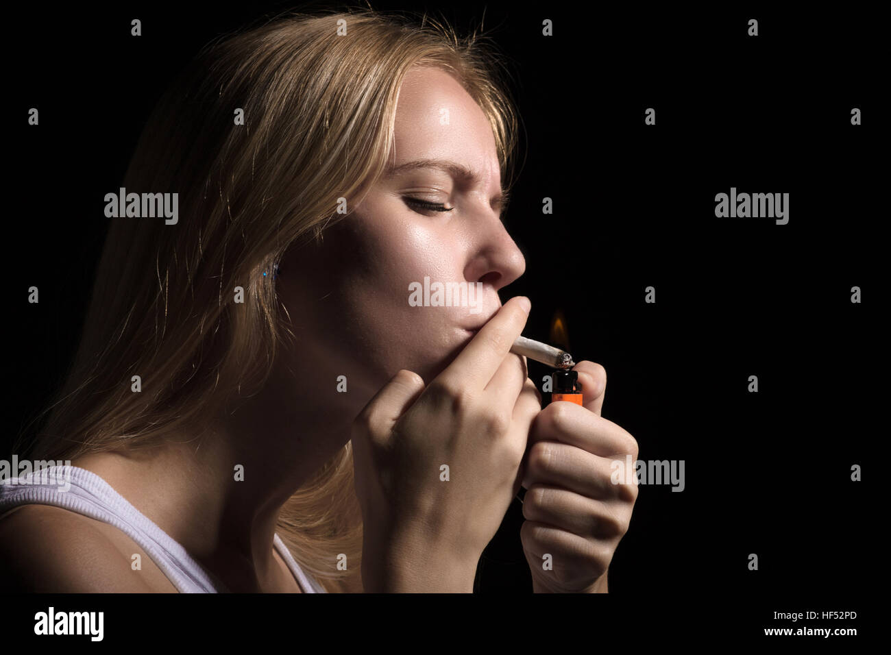 woman smoking joint of marijuana on black background Stock Photo - Alamy