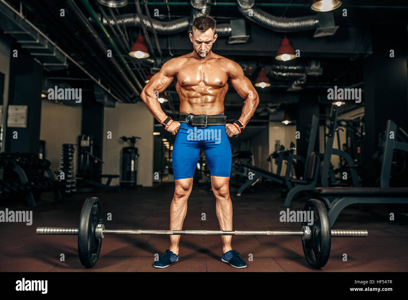 Strong Bodybuilder preparing for deadlift of barbell in the gym Stock ...