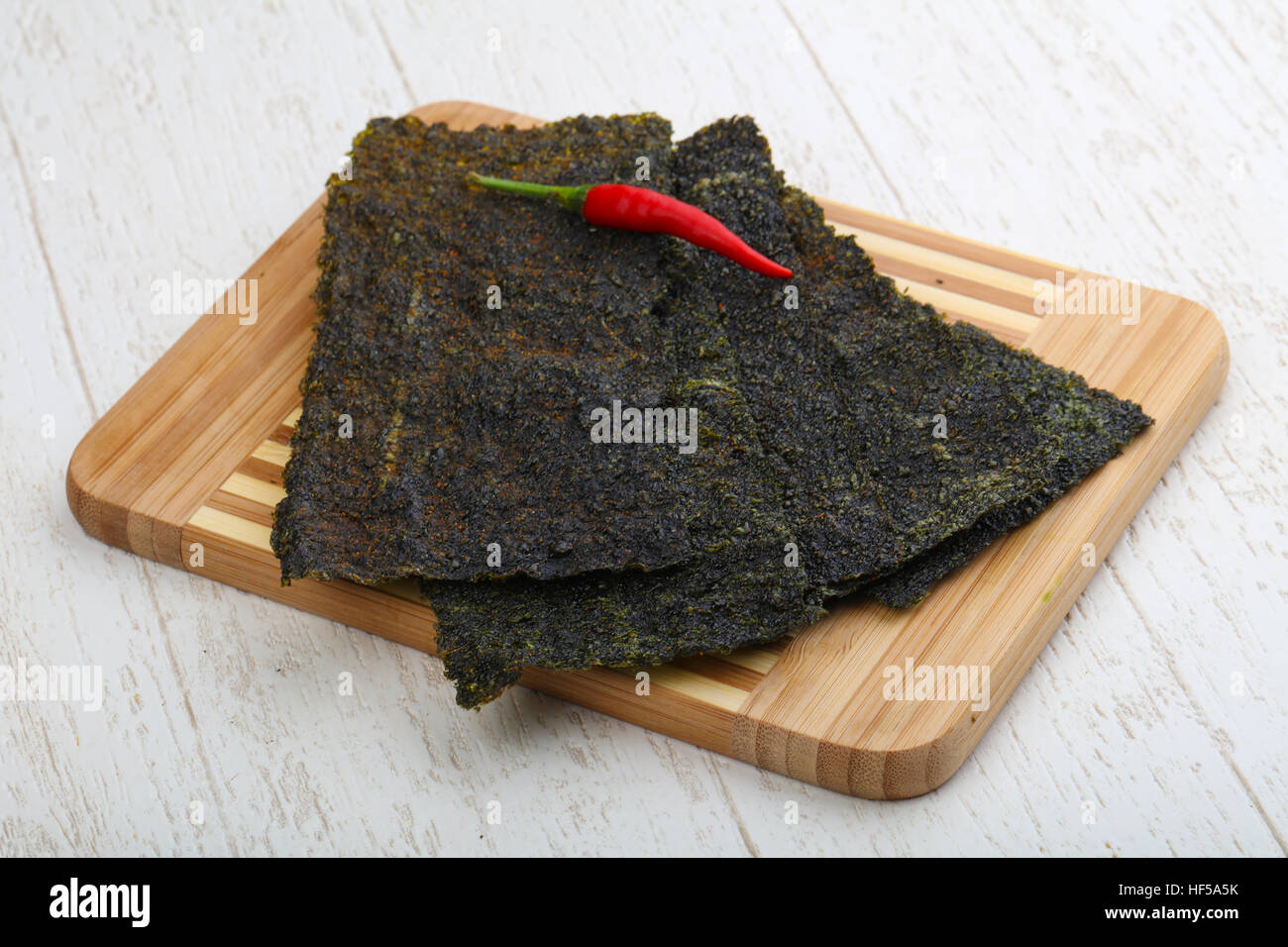 Spicy Nori seaweed sheets with pepper on wood Stock Photo - Alamy