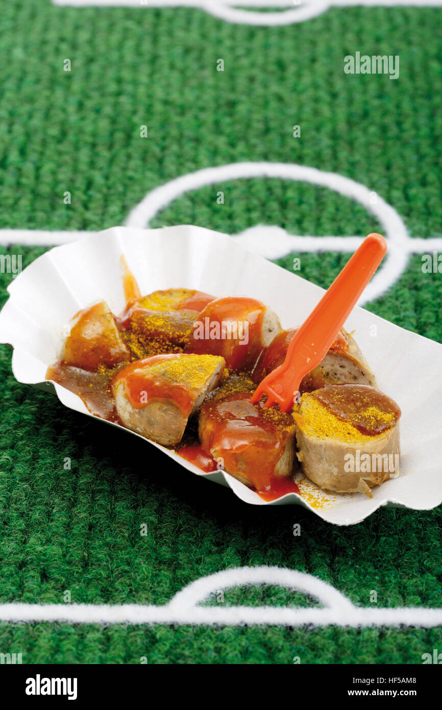 Football fast food - curry sausage on tray set on soccer turf Stock ...