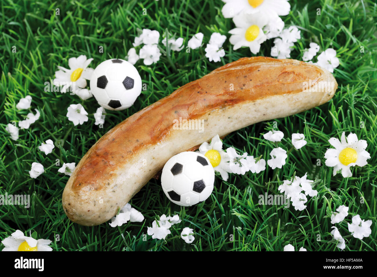 Football fast food - bratwurst and mini footballs on lawn Stock Photo ...