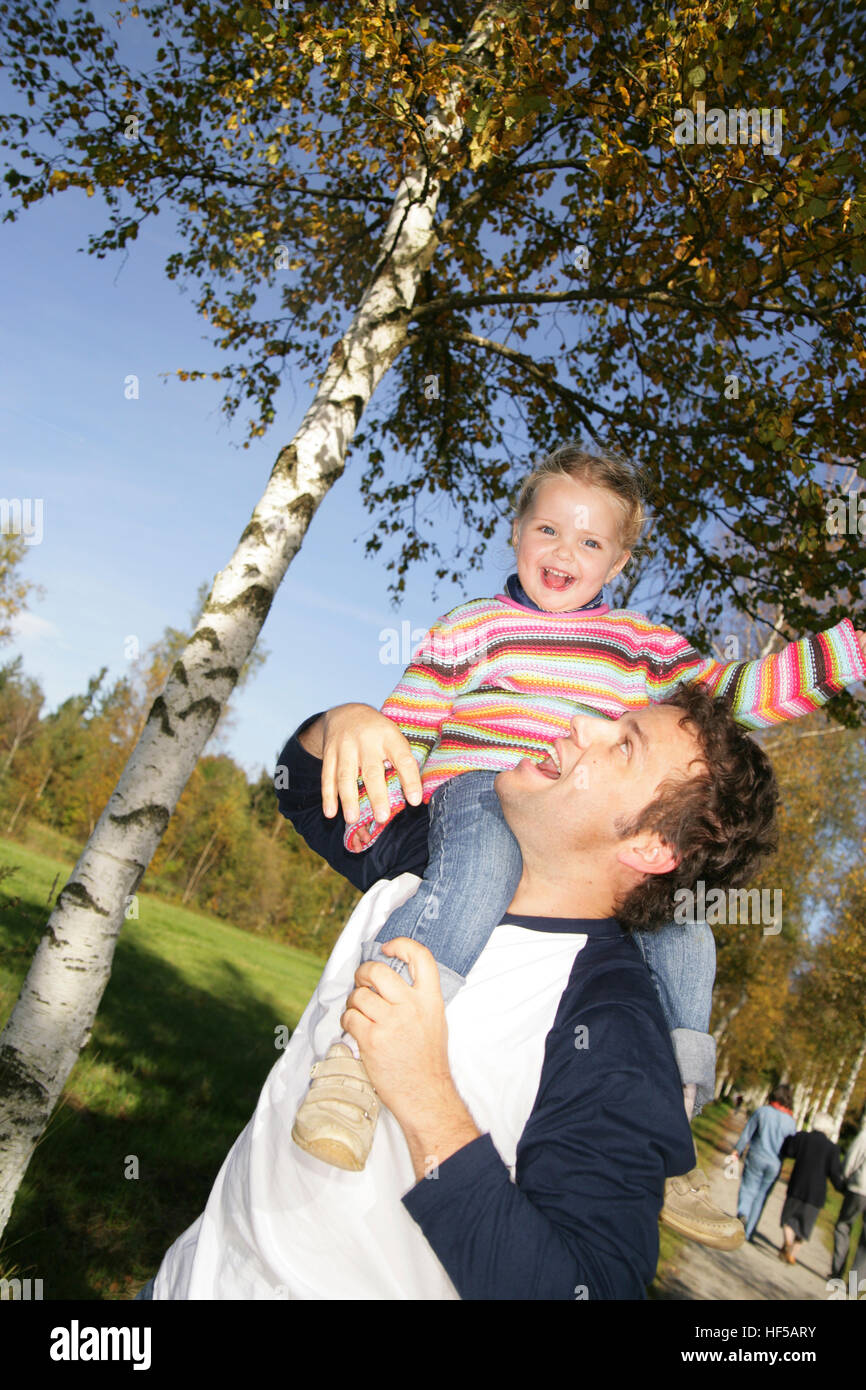 Father giving his three-year-old daughter a piggyback ride Stock Photo ...