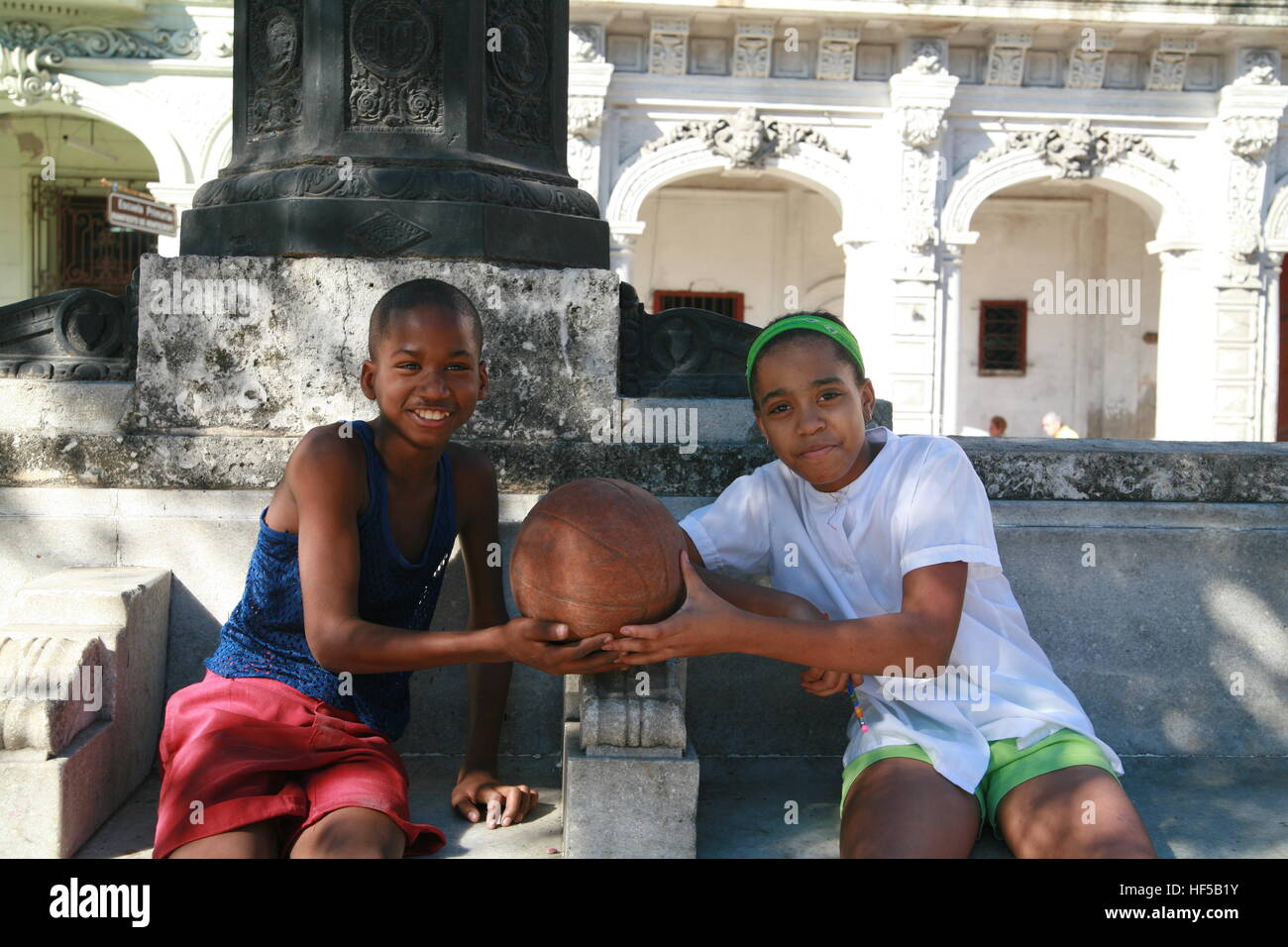 Two boys sitting on a bench holding a basketball, Paseo de Martí Street ...