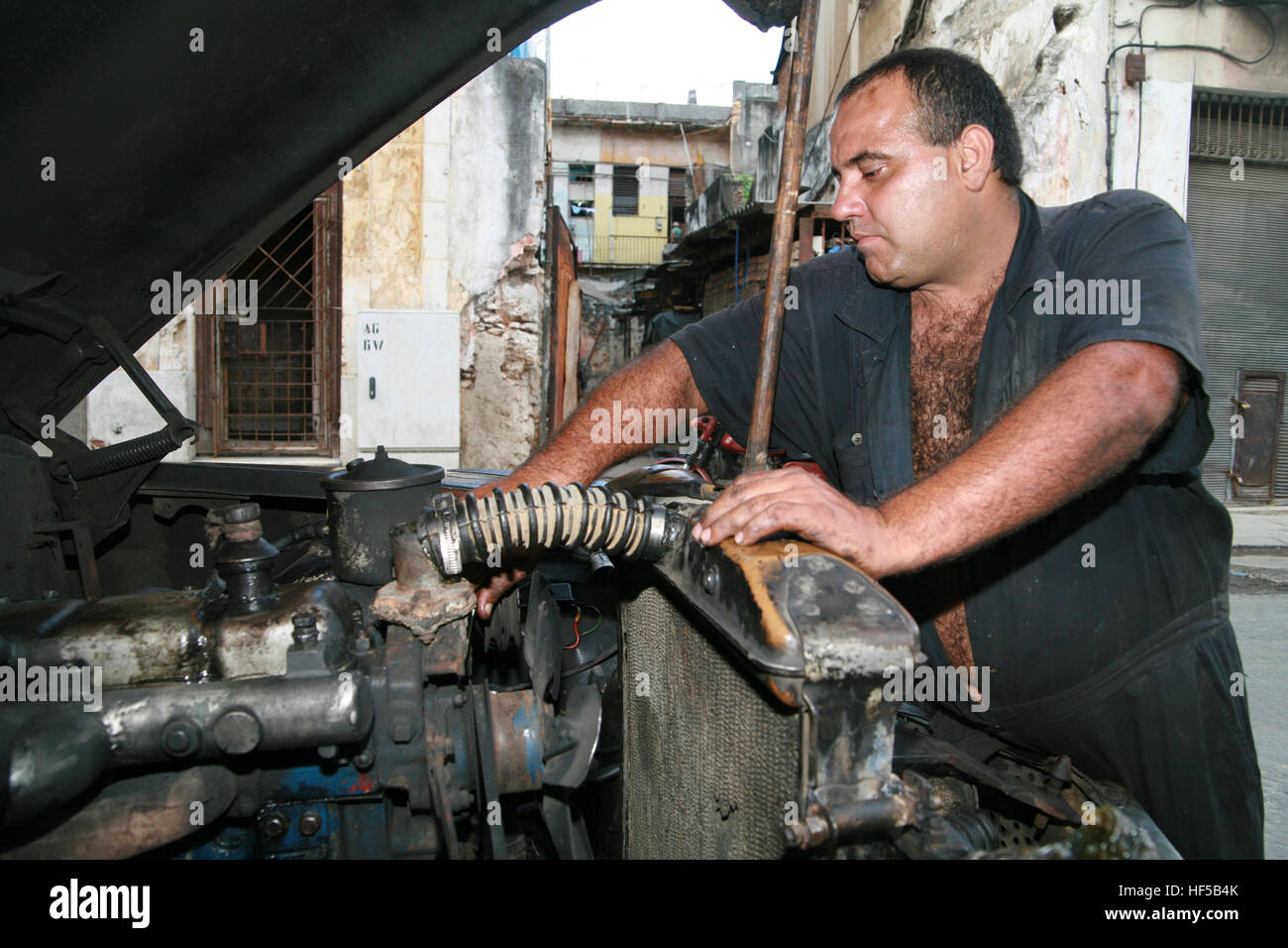 A private taxi driver working on his 59-year-old classic car, all ...
