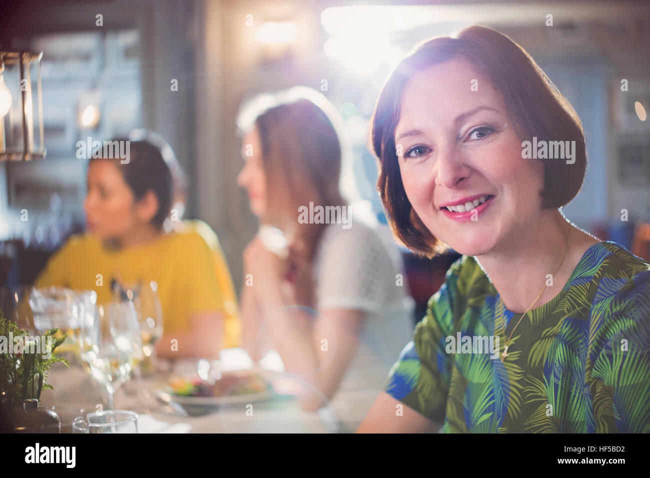 Portrait smiling woman dining with friends at restaurant table Stock ...