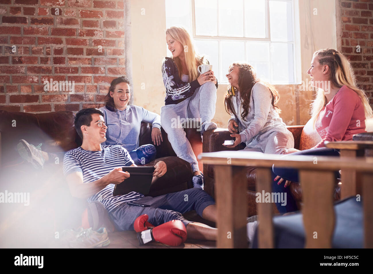 Young friends talking and hanging out in studio Stock Photo - Alamy