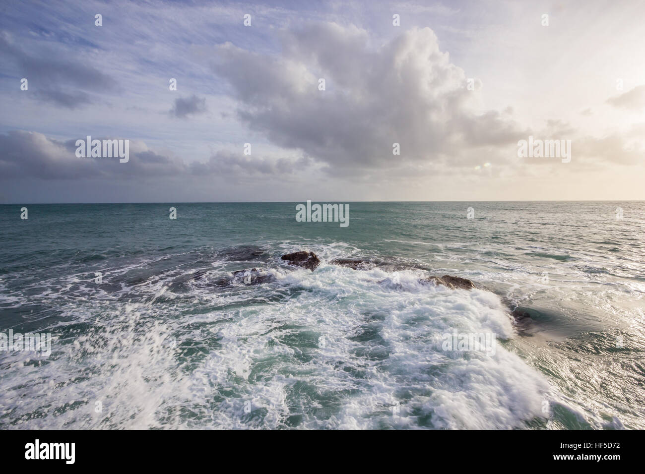 Rocks beneath the surface cause water to break over them, Isles of ...
