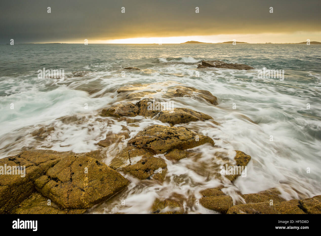 The sun setting behind the uninhabited island of Samson, Isles of ...