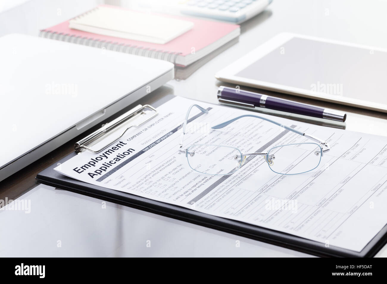 Businessman or job seeker fill in Employment Application form with pen ...