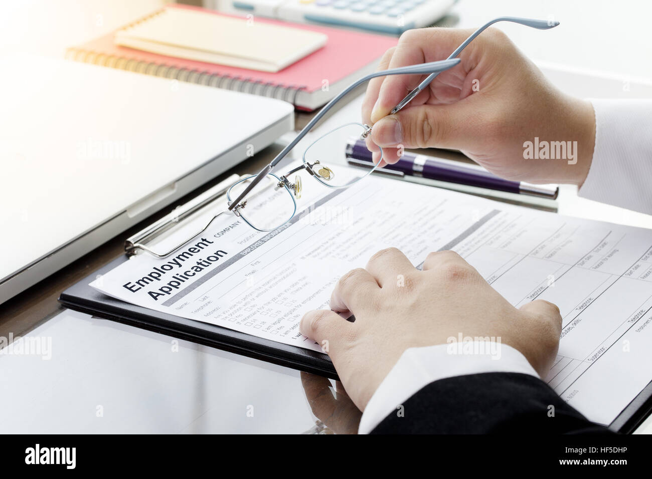 Businessman or HR Manager review a blank Employment Application form ...