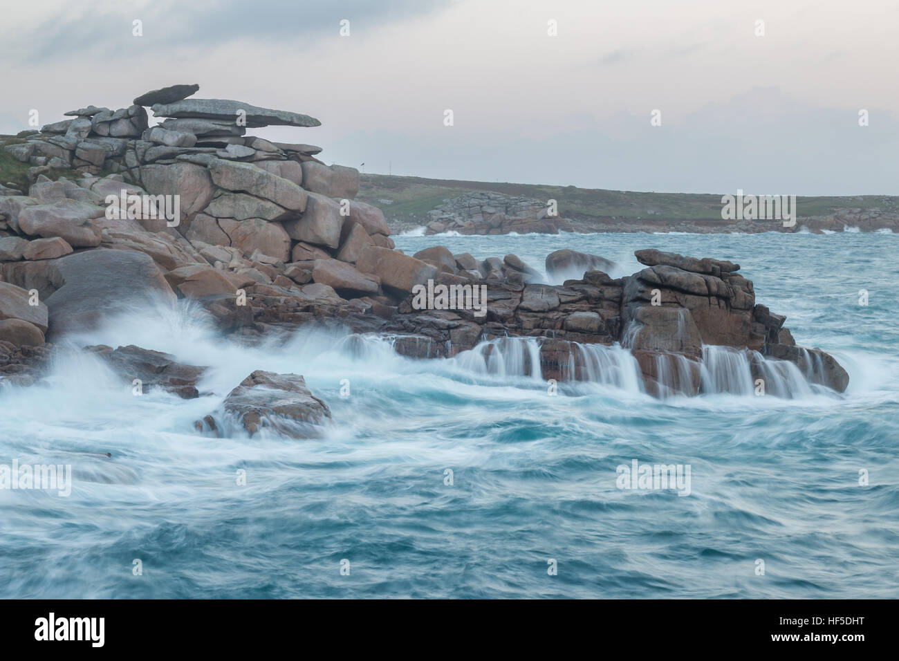 Waves wash over the rocky coast underneath Pulpit Rock on Peninnis, St ...