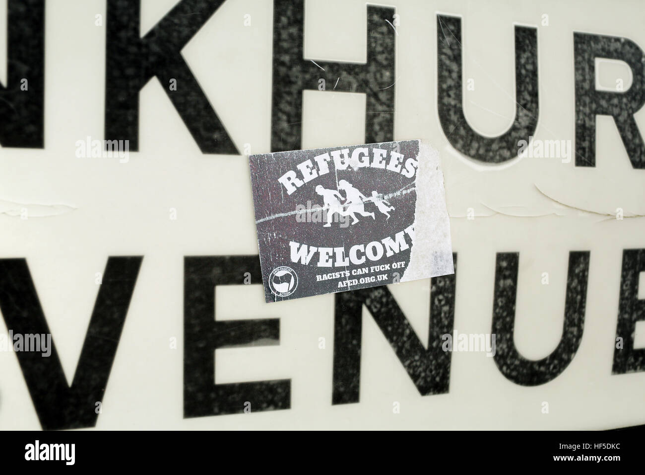 refugee sticker on street sign Stock Photo - Alamy