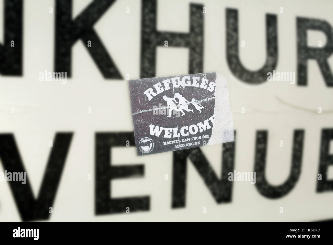 refugee sticker on street sign Stock Photo - Alamy