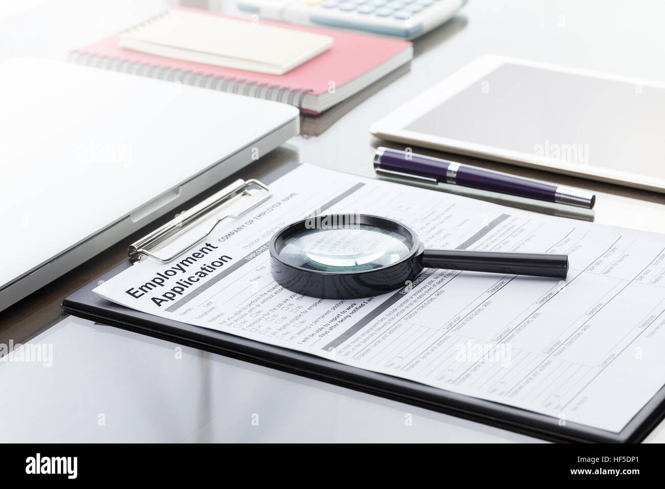 Businessman or HR Manager review a blank Employment Application form ...