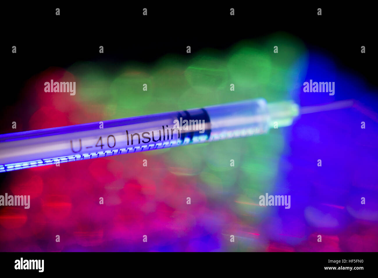Insulin syringe on multicolored background out of focus Stock Photo - Alamy
